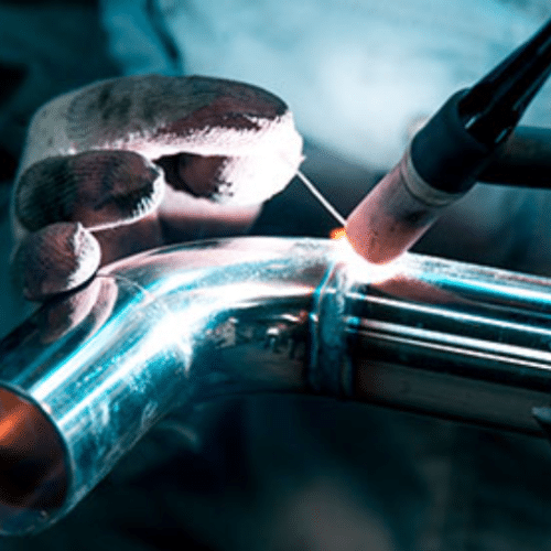 What toxic substance is released when welding stainless steel?
